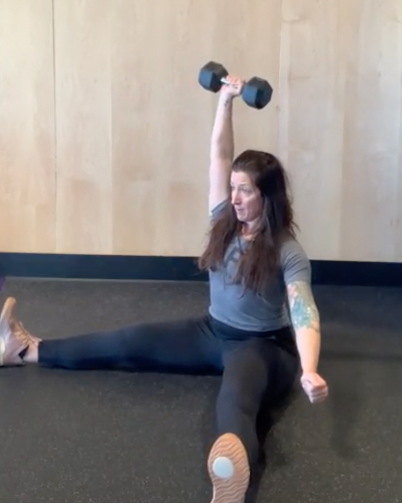 woman-doing-seated-single-arm-overhead-press-2 - Anytime Fitness